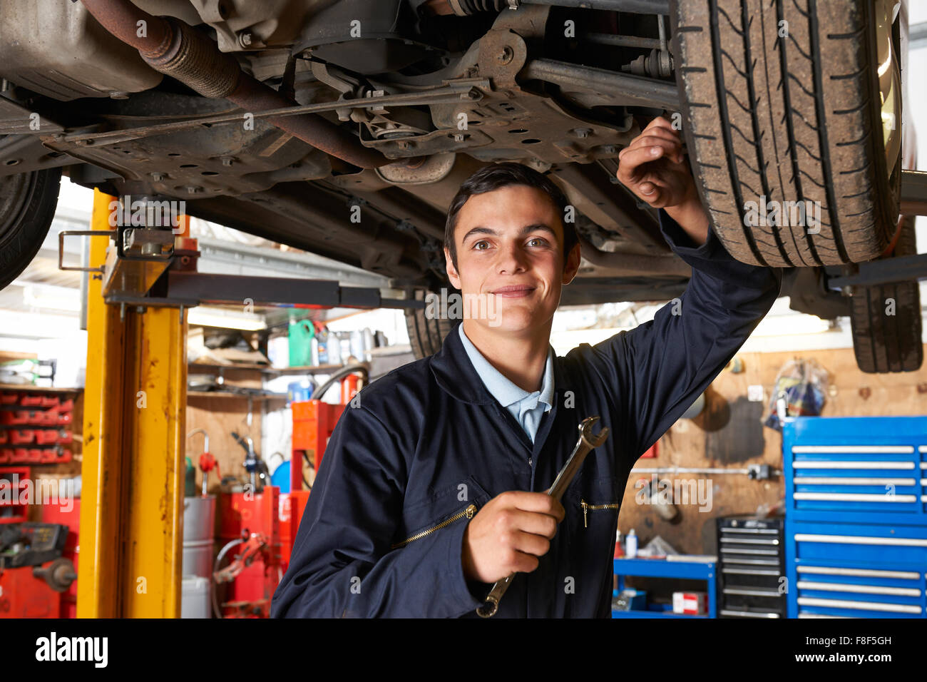 Trainee Mechanic Working Under Car Stock Photo - Alamy