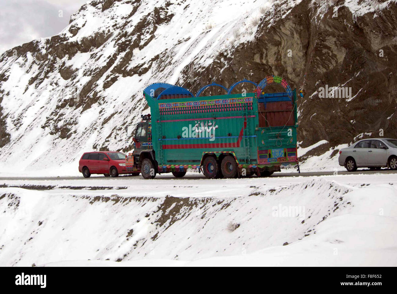 Commuters pass through road while snow covered area after first heavy ...
