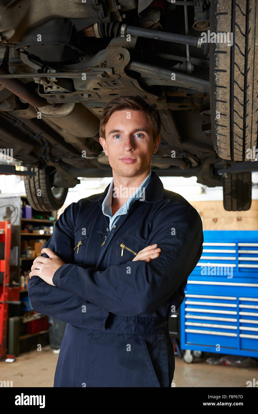 Portrait Of Mechanic Standing Under Car Stock Photo - Alamy