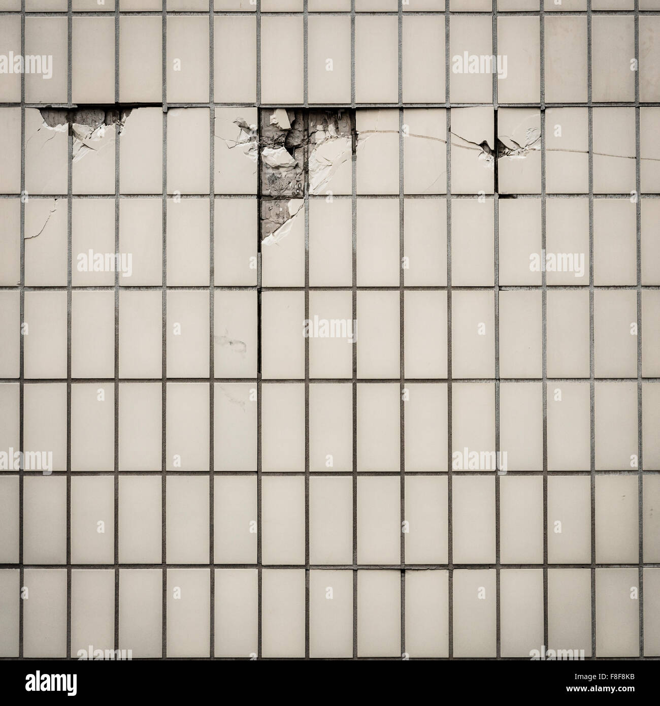 Tile wall where some tiles cracked Stock Photo - Alamy