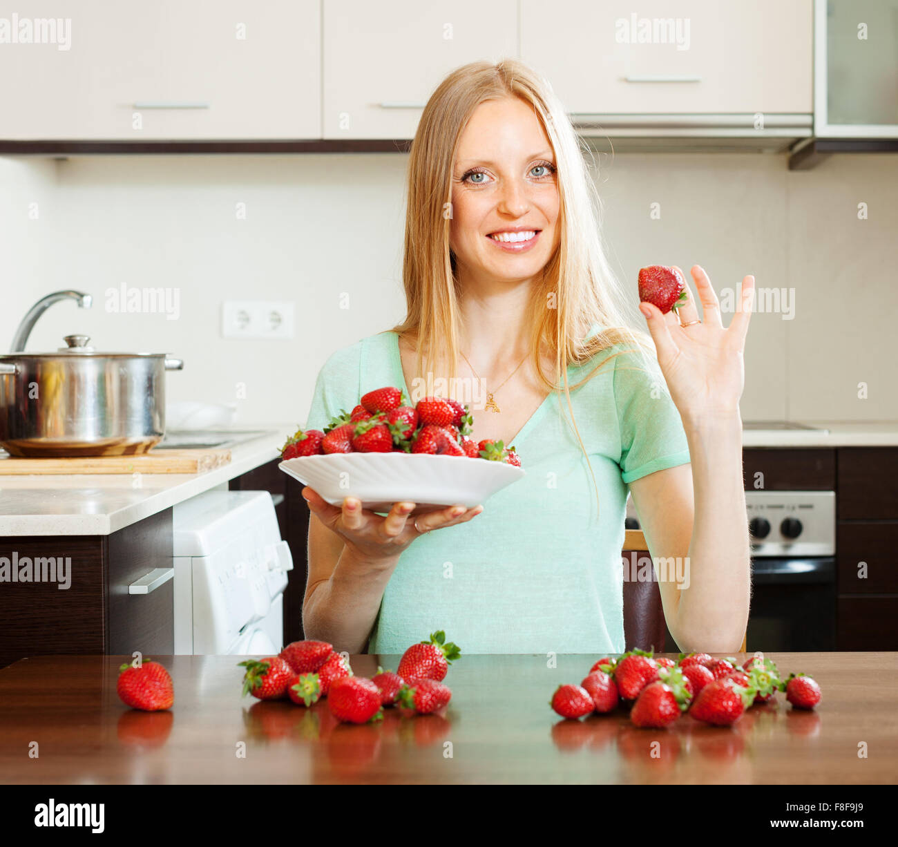 blonde long-haired girl with strawberries Stock Photo - Alamy