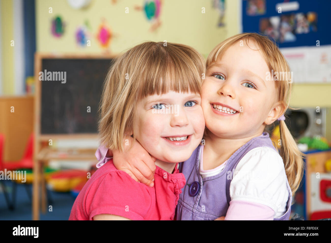 Two Female Pre School Pupils Hugging One Another Stock Photo - Alamy