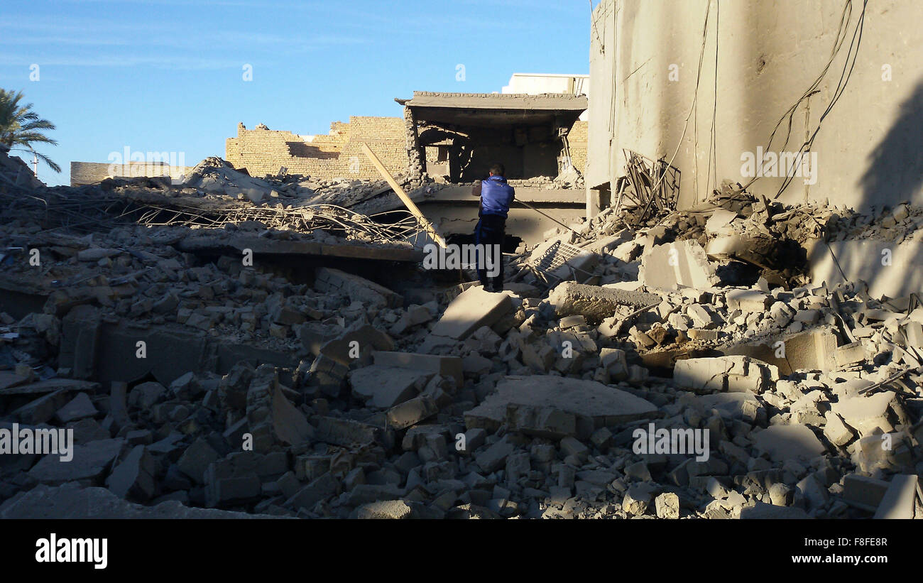 Fallujah, Iraq. 9th Dec, 2015. A man stands by destroyed buildings ...