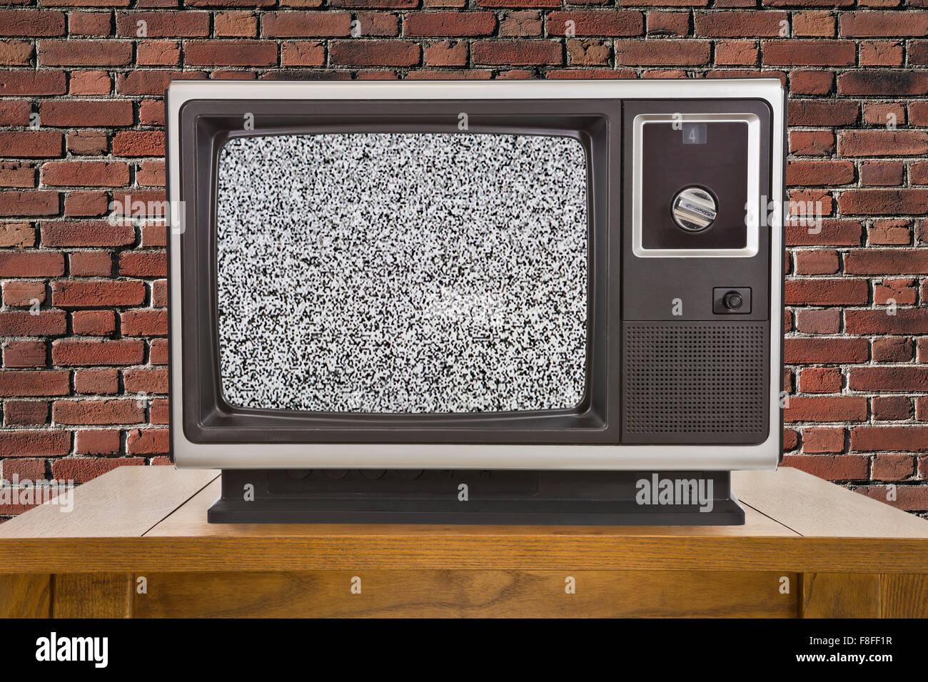 Old television with static screen and brick wall Stock Photo - Alamy