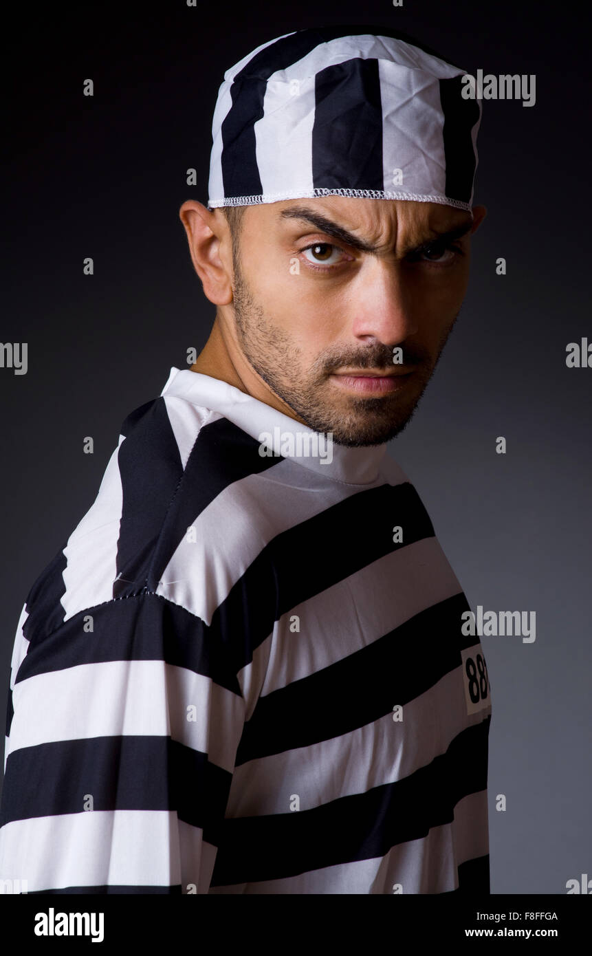 Angry prison inmate in dark room Stock Photo - Alamy