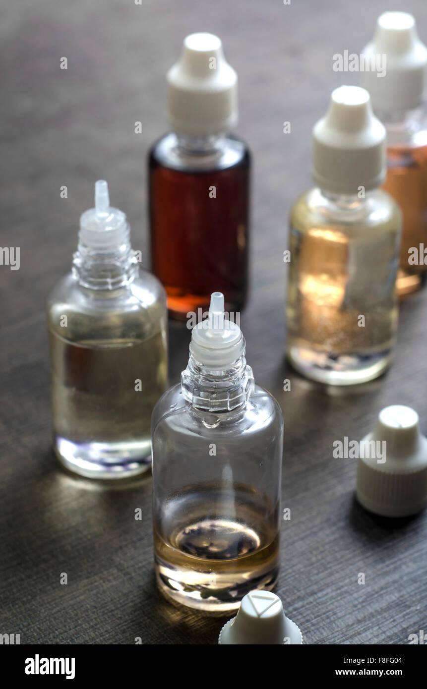 E cigarettes Liquid Bottle on wooden table, close up Stock Photo - Alamy