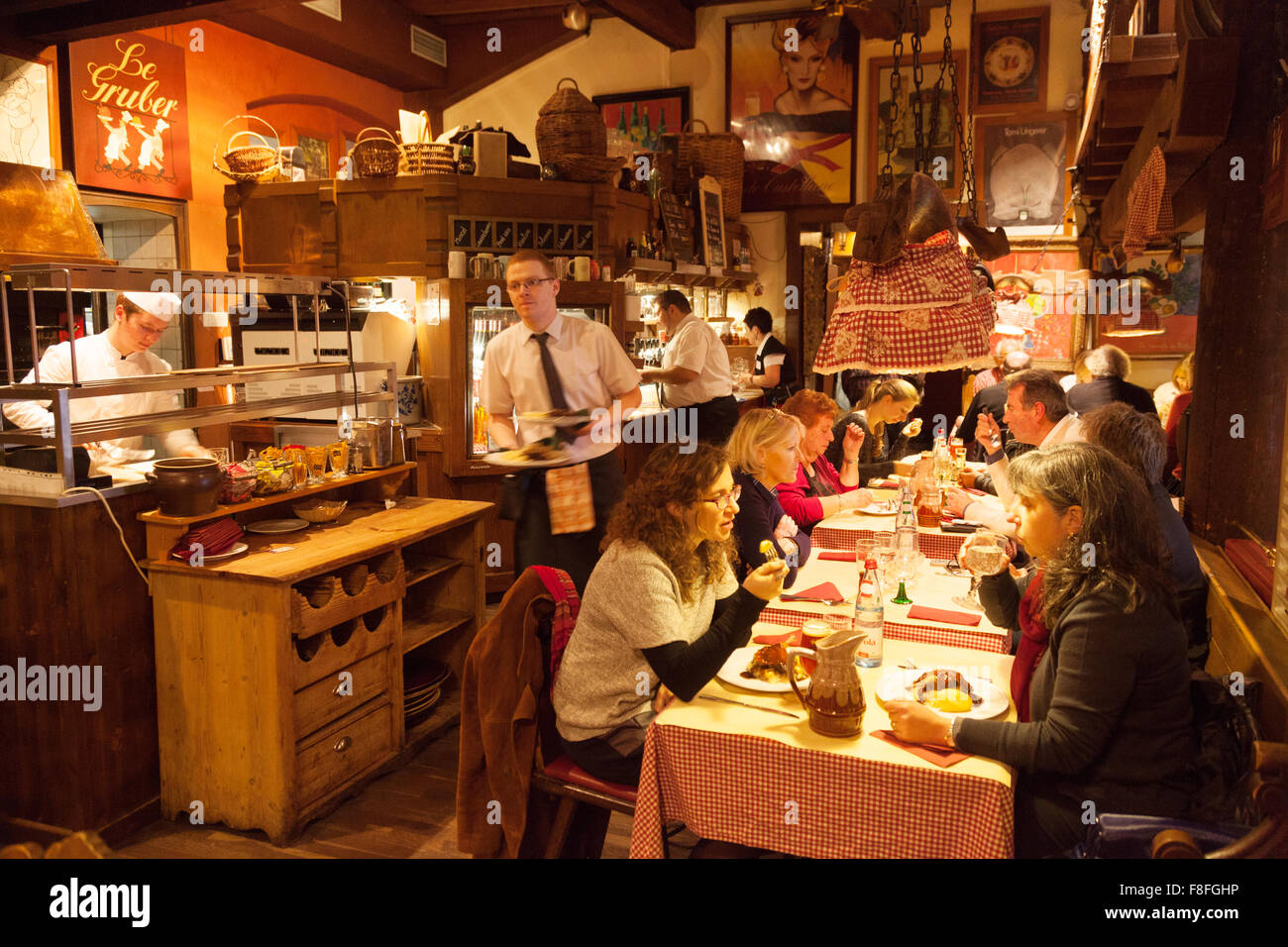Strasbourg restaurant; people eating food inside Le Gruber restaurant ...