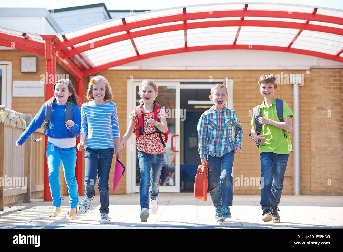 Schoolchildren Running Into Playground At End Of Class Stock Photo - Alamy