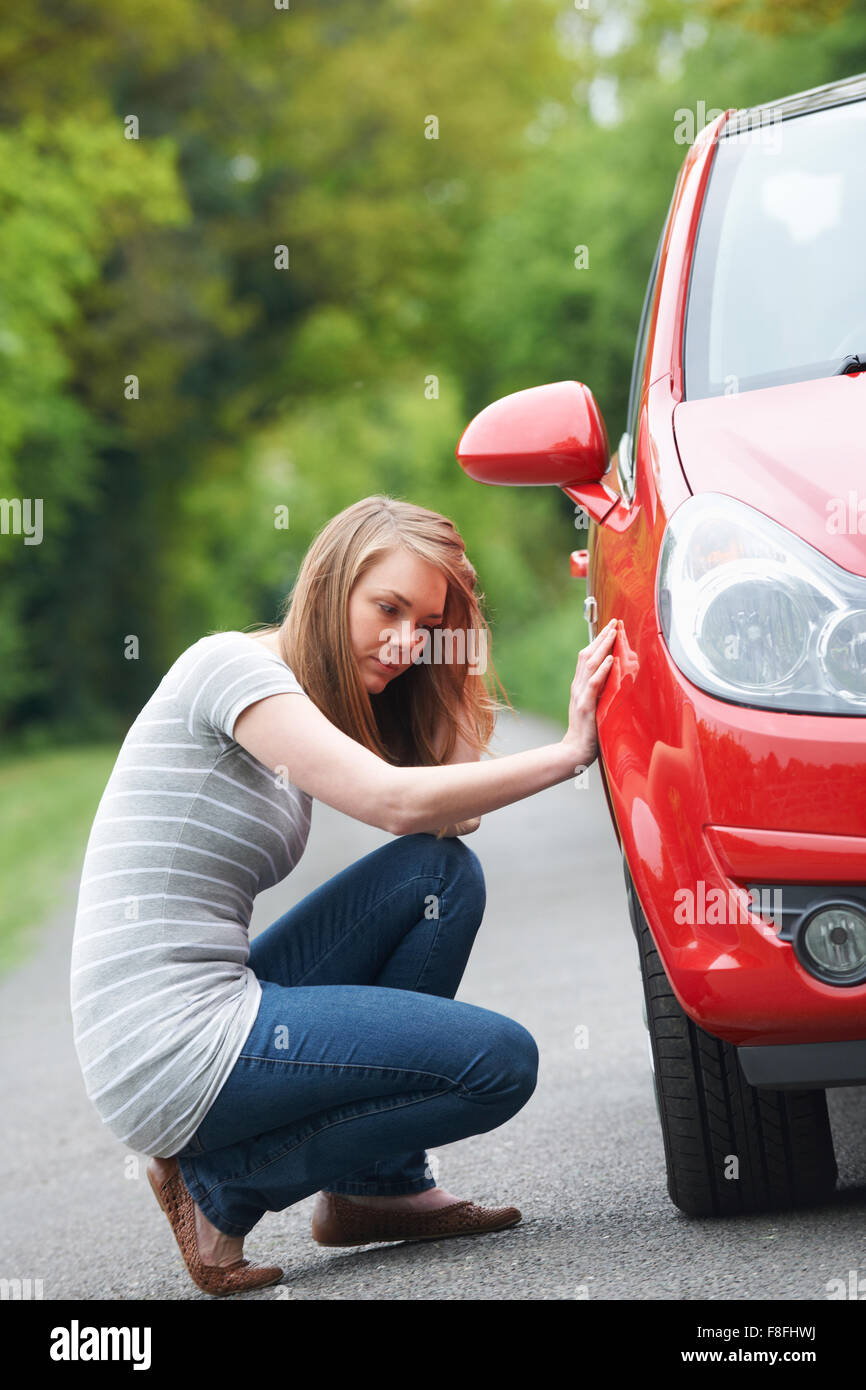 Female Motorist With Puncture On Country Road Stock Photo - Alamy