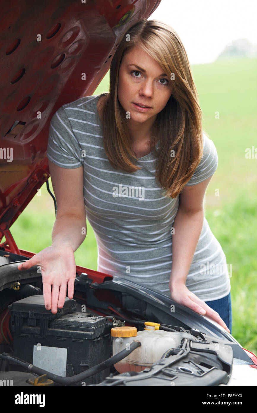 Broken Down Female Motorist Looking At Car Engine Stock Photo - Alamy