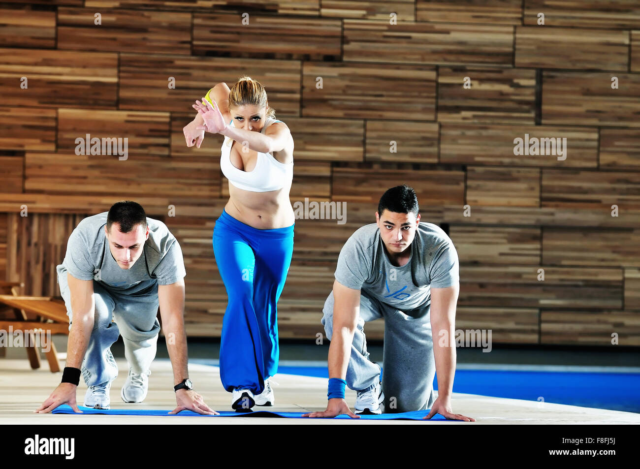 fitness personal trainer on fitness classes supporting group of people ...