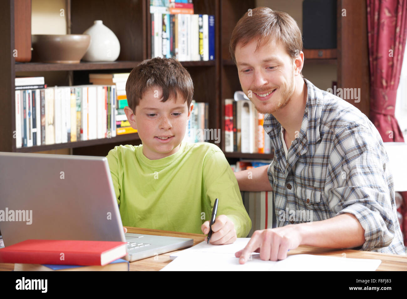 Boy Studying With Home Tutor Stock Photo - Alamy