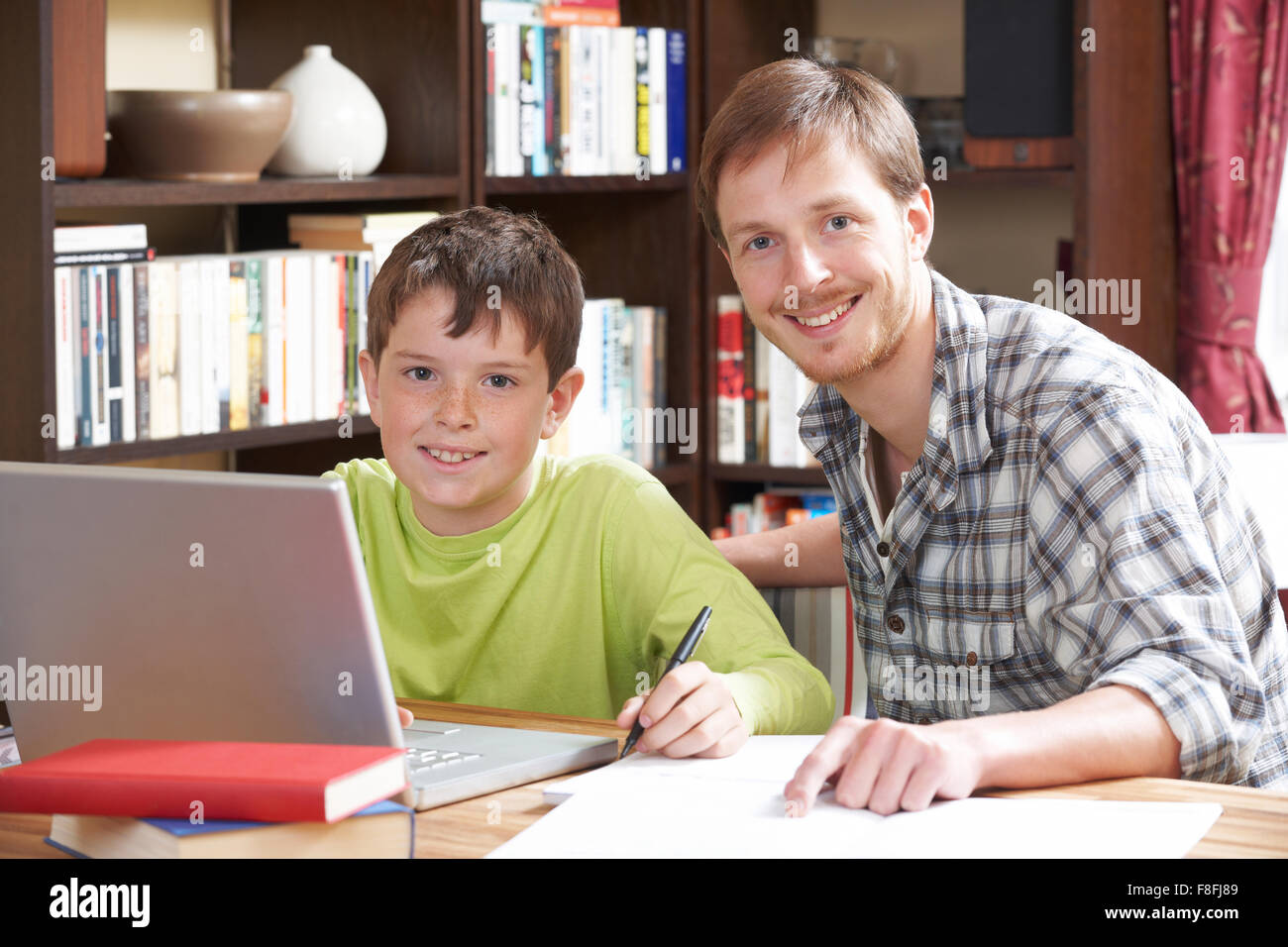 Boy Studying With Home Tutor Stock Photo - Alamy