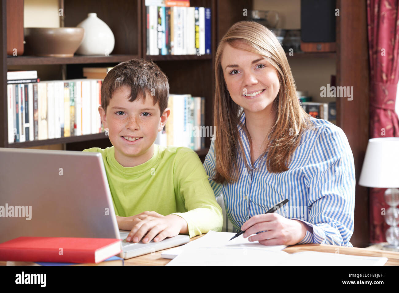 Tutor Helping Boy Studying At Home Stock Photo - Alamy
