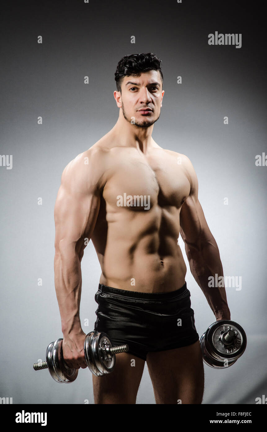 Muscular ripped bodybuilder with dumbbells Stock Photo - Alamy