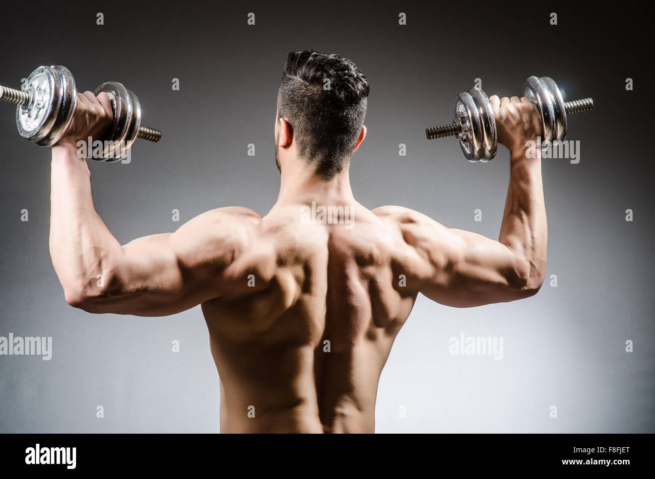 Muscular ripped bodybuilder with dumbbells Stock Photo - Alamy