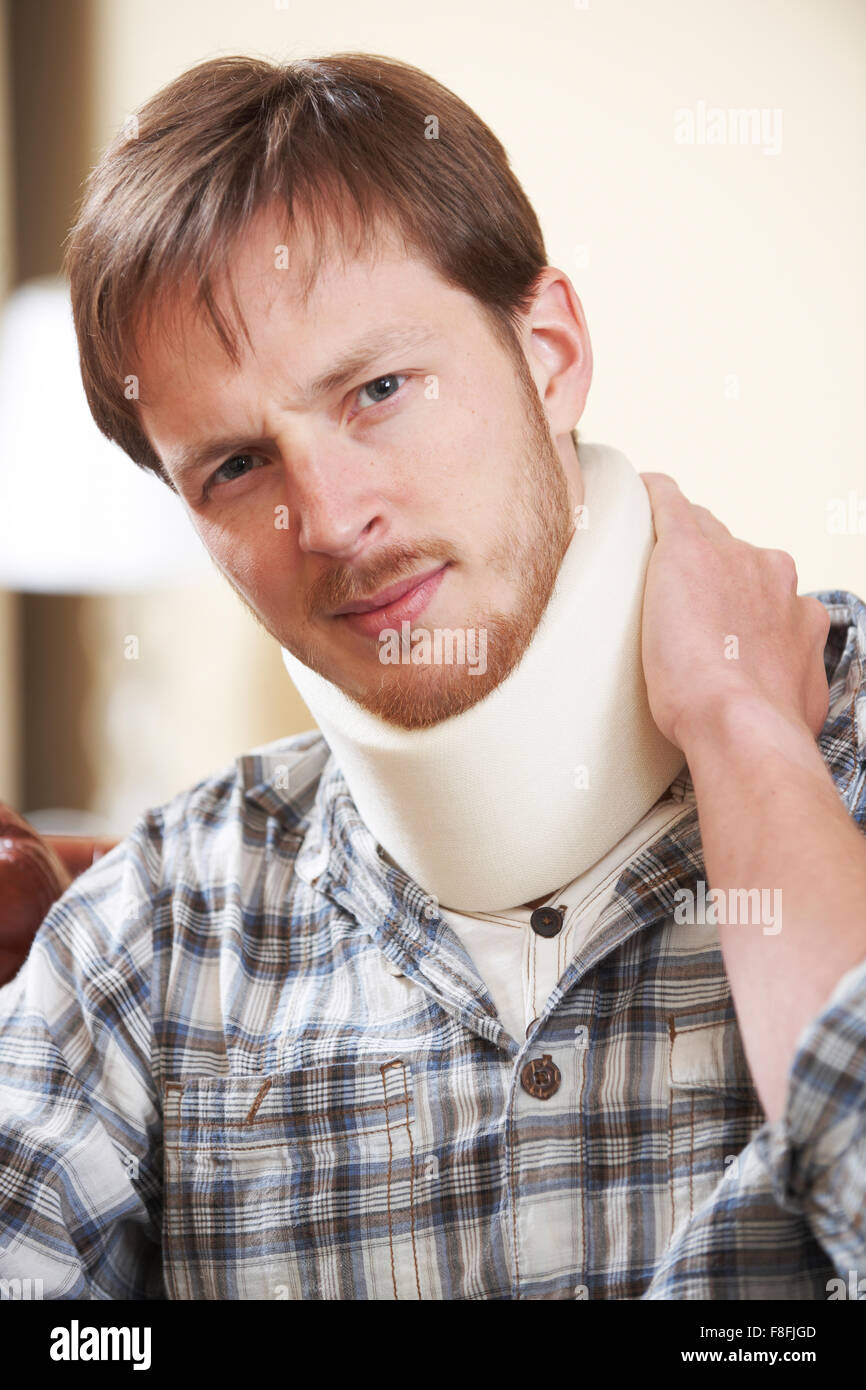 Man Wearing Surgical Collar In Pain Stock Photo - Alamy