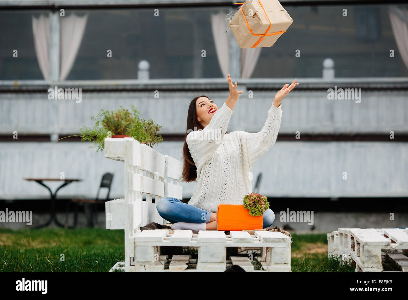 Young girl throws a gift Stock Photo - Alamy