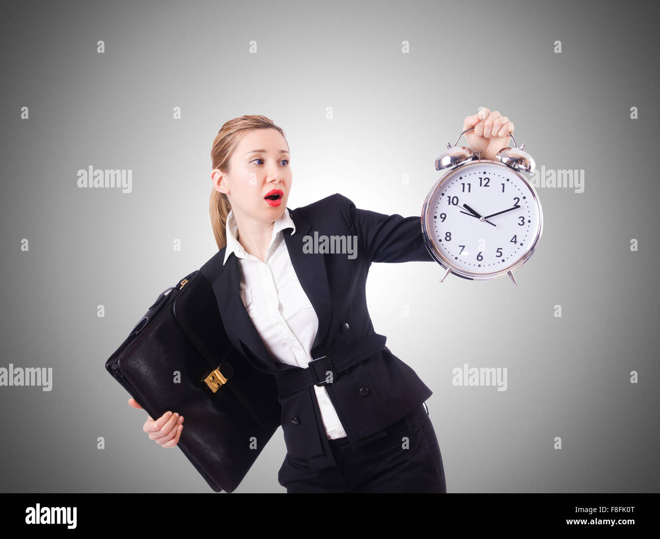 Woman businesswoman with giant clock Stock Photo - Alamy