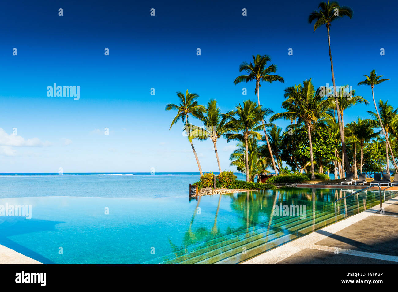 A stunning infinity swimming pool and beach on the tropical Island of ...