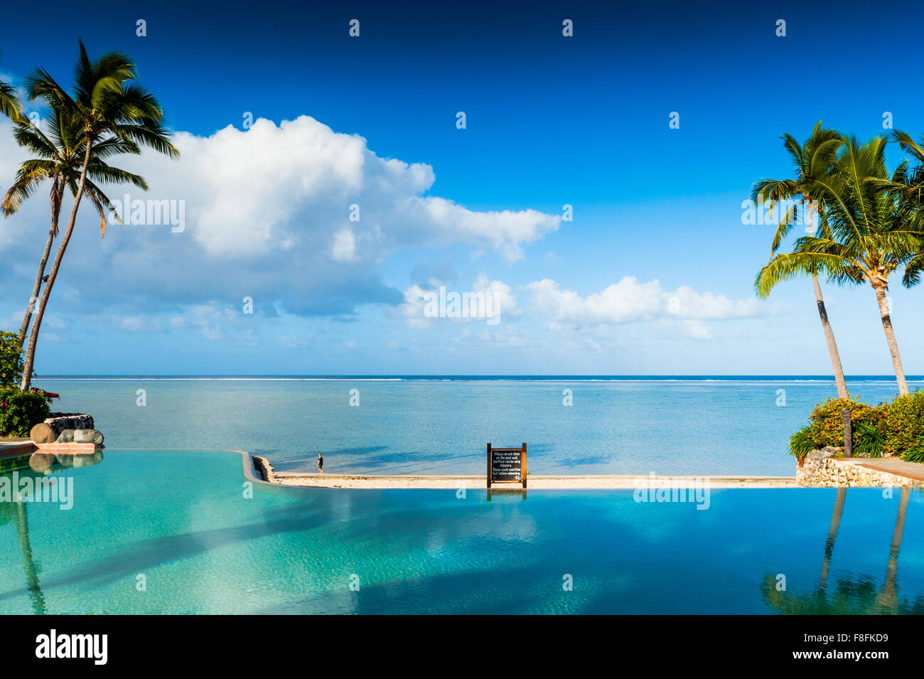 A stunning infinity swimming pool and beach on the tropical Island of Fiji in the South Pacific ...
