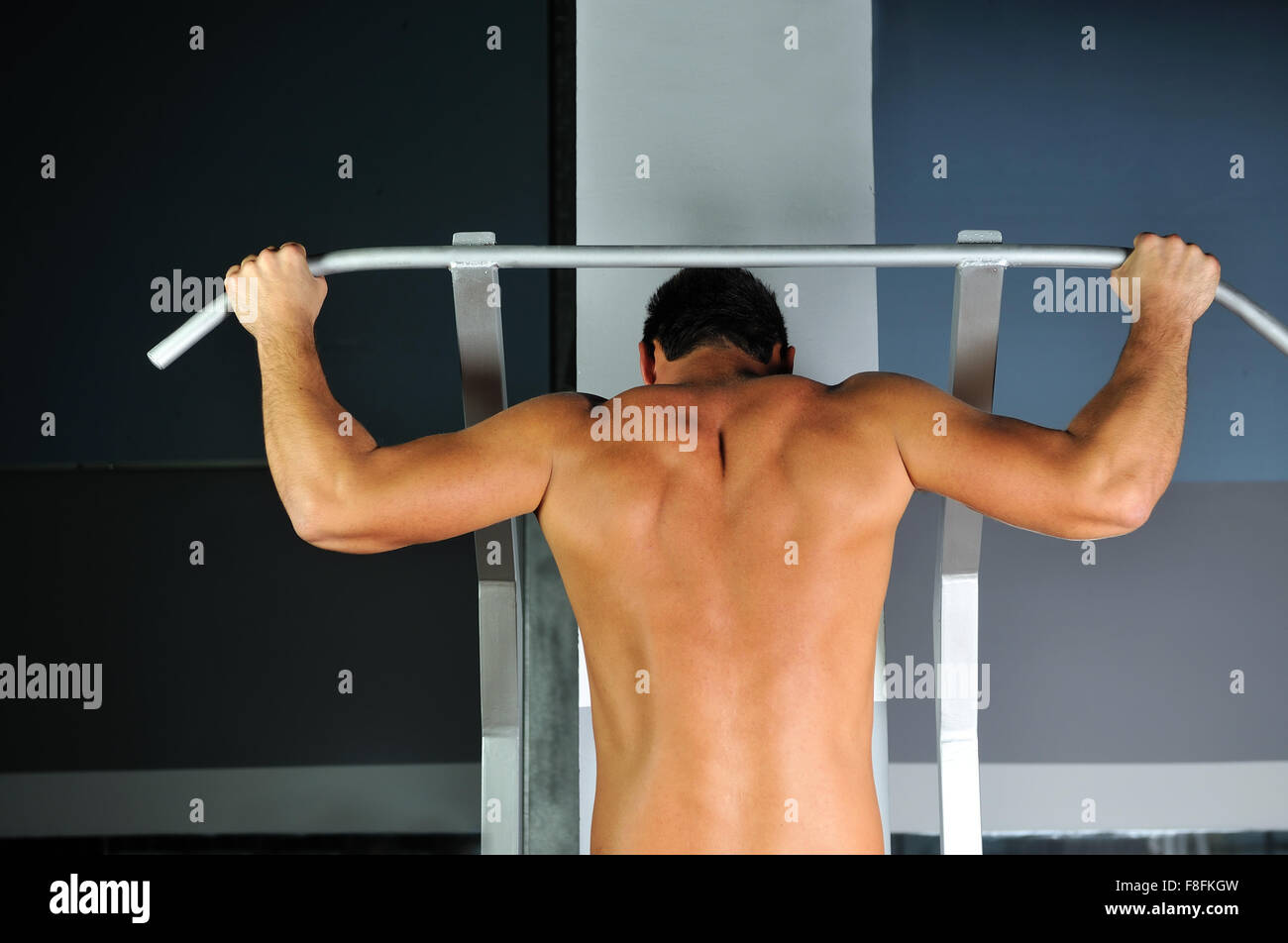 young man with strong arms working out in gym and representing their ...