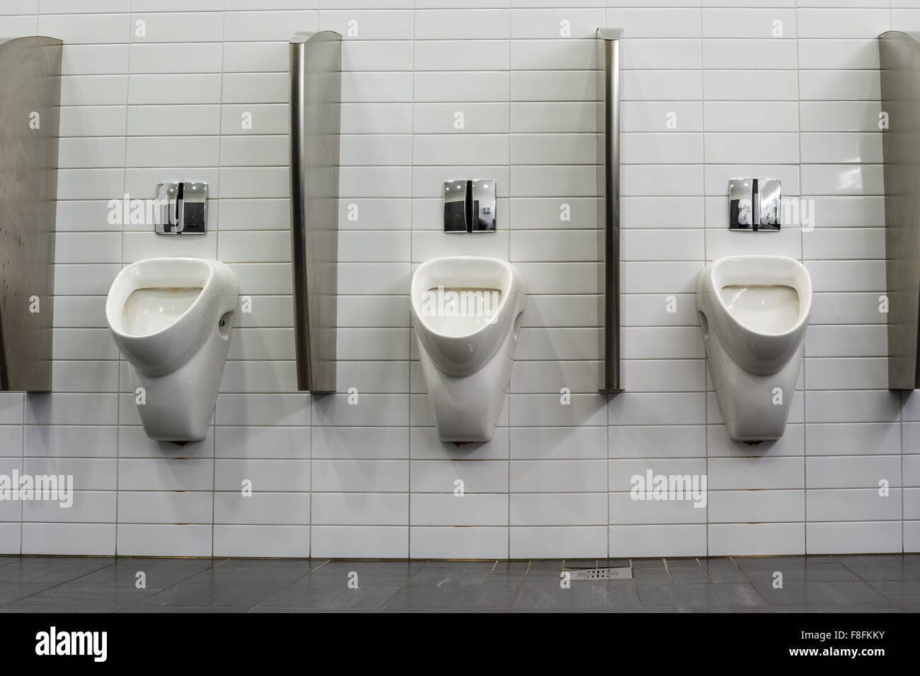 urinals in an new building for men only Stock Photo - Alamy