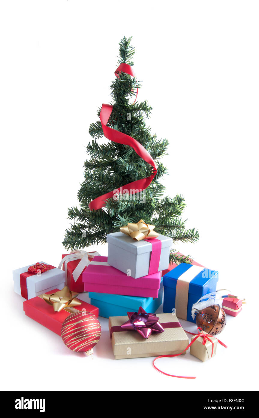 Many wrapped gift boxes around a christmas tree over a white background ...