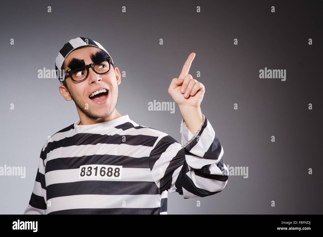 Funny prisoner isolated on gray Stock Photo - Alamy