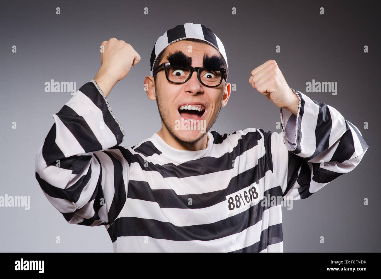 Funny prisoner isolated on gray Stock Photo - Alamy