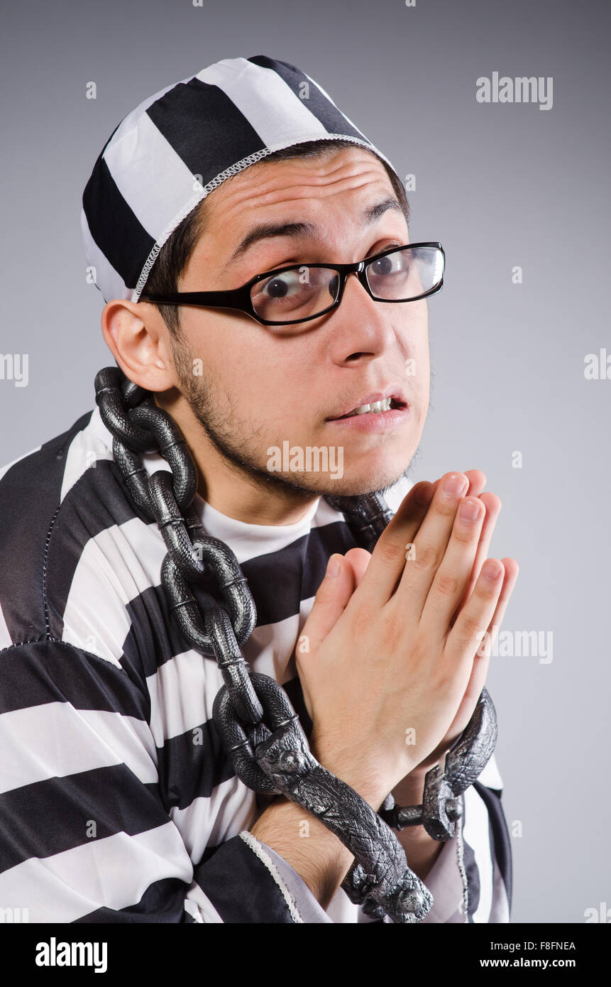 Funny prisoner in chains isolated on gray Stock Photo - Alamy