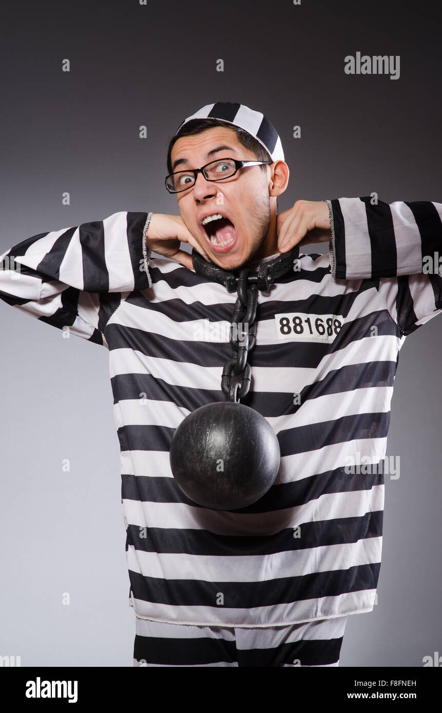 Funny prisoner in chains isolated on gray Stock Photo - Alamy