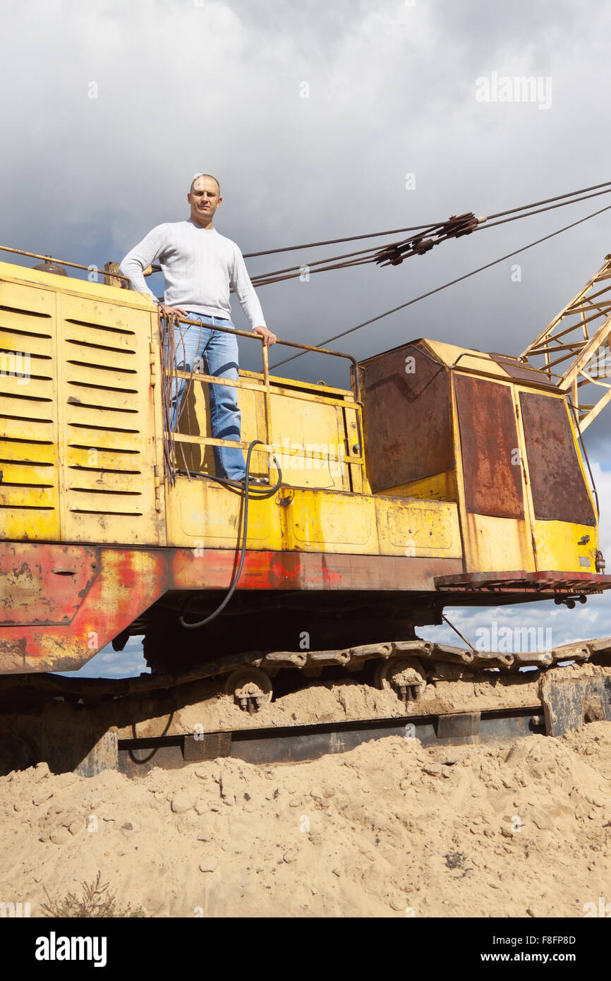 Portrait of tractor operator at sand pit Stock Photo - Alamy