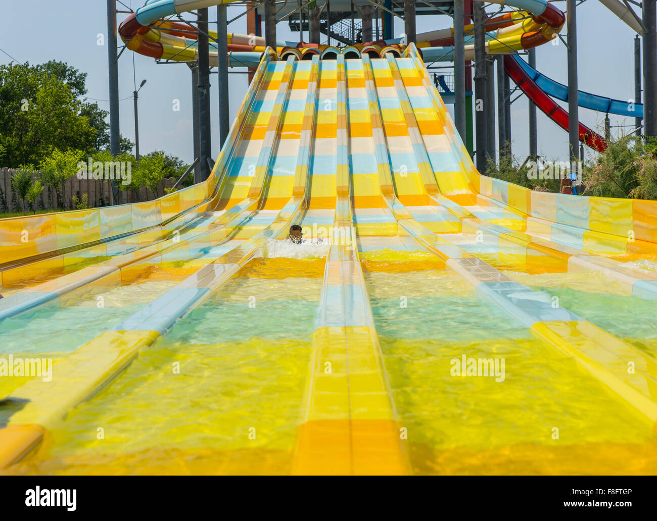 Colorful curved water slide at an amusement park or tropical resort ...