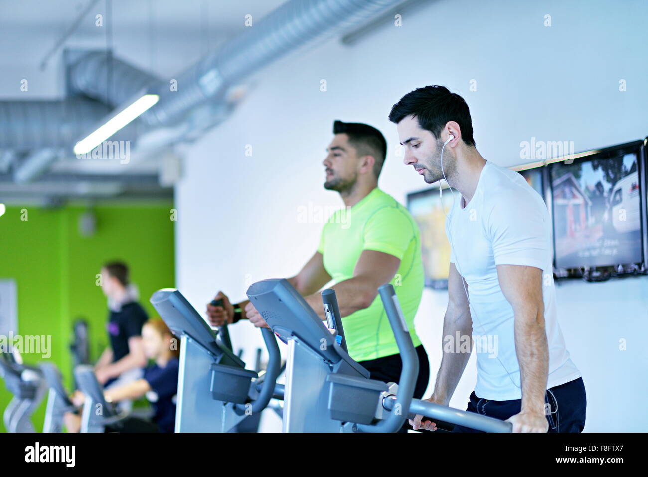 group of young people running on treadmills in modern sport gym Stock ...