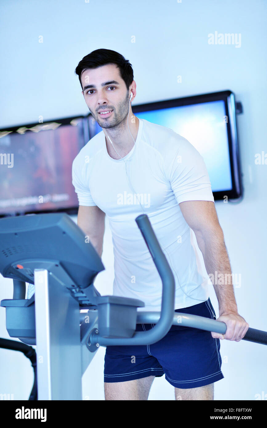 Handsome man running on the treadmill in modern gym Stock Photo - Alamy