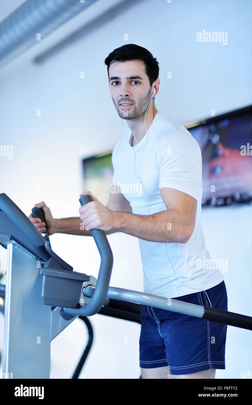 Handsome man running on the treadmill in modern gym Stock Photo - Alamy