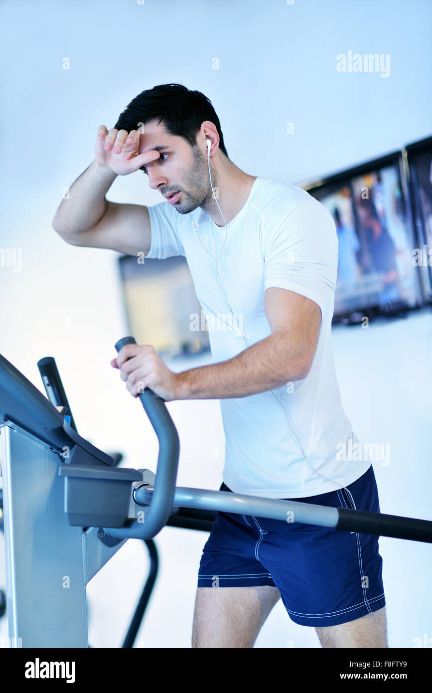 Handsome man running on the treadmill in modern gym Stock Photo - Alamy