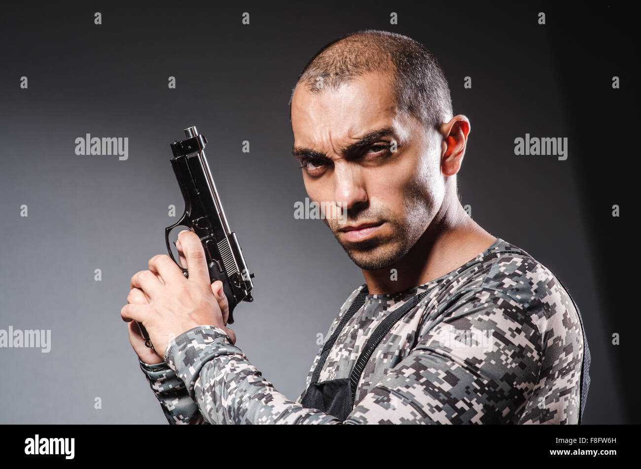 Soldier with guns against dark background Stock Photo - Alamy