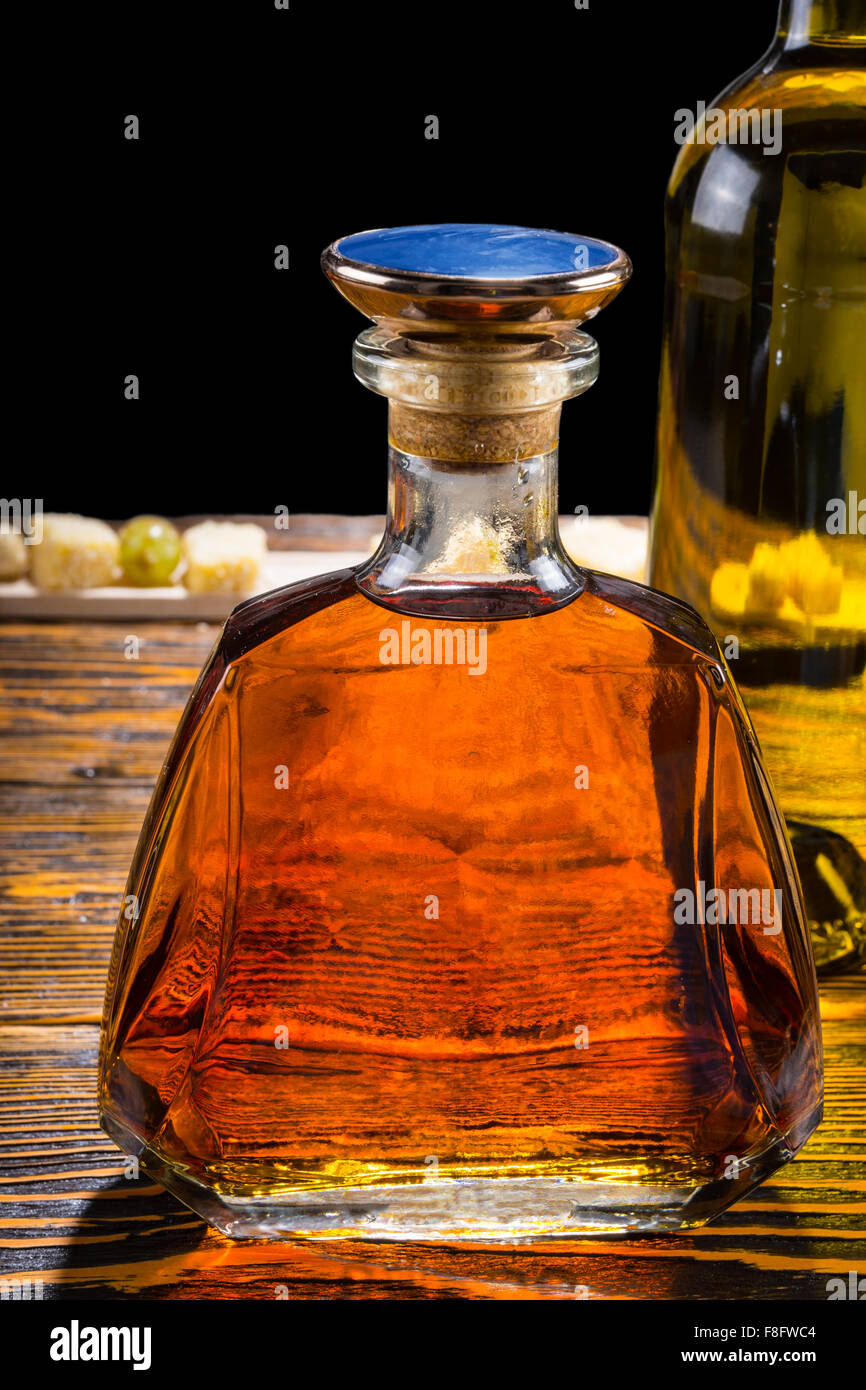 Modern stylish glass whiskey decanter with a blue stopper and a wine ...