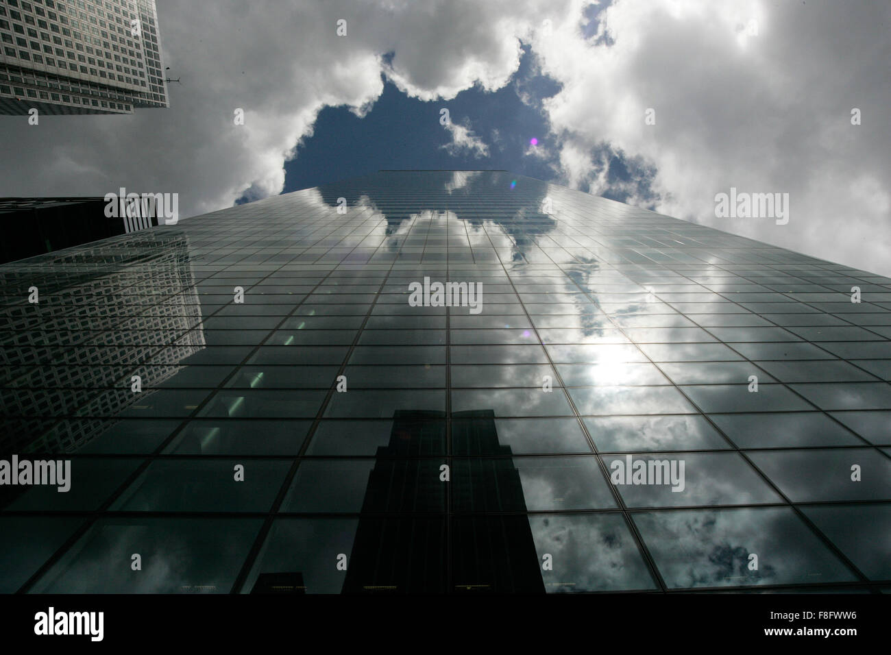 Blue sky and clouds reflected in tall glass mirrored building Stock ...
