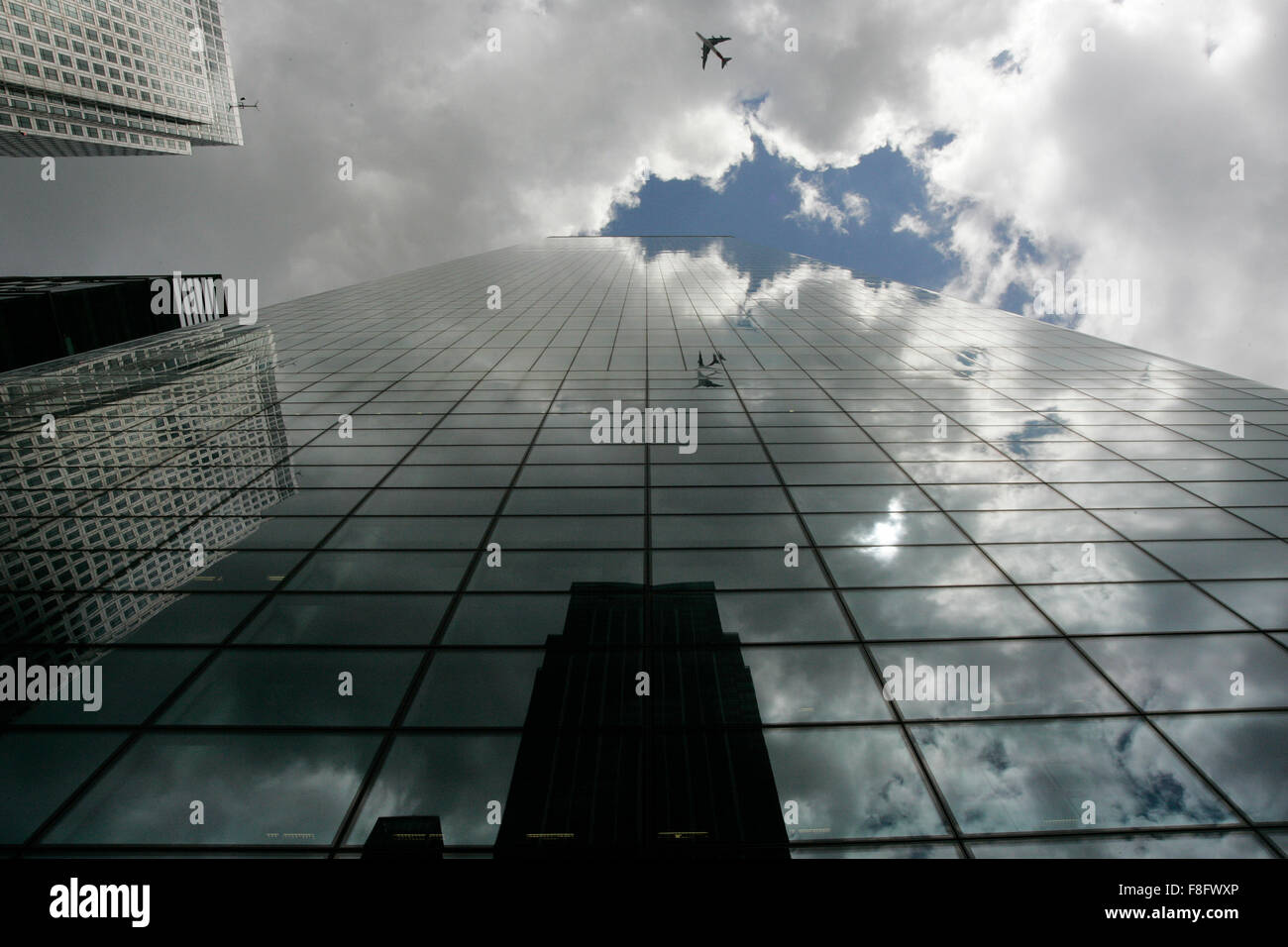 Cloud and sky reflection on glass building with plane Stock Photo - Alamy