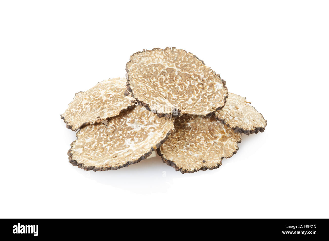 Black truffle slices heap on white Stock Photo - Alamy