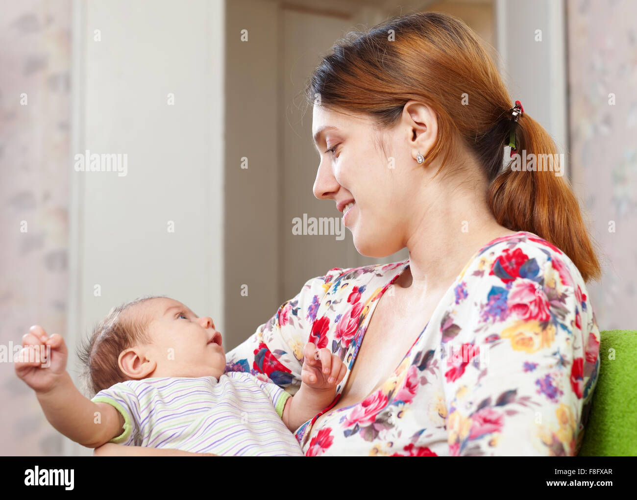 mother with baby in home interior Stock Photo - Alamy