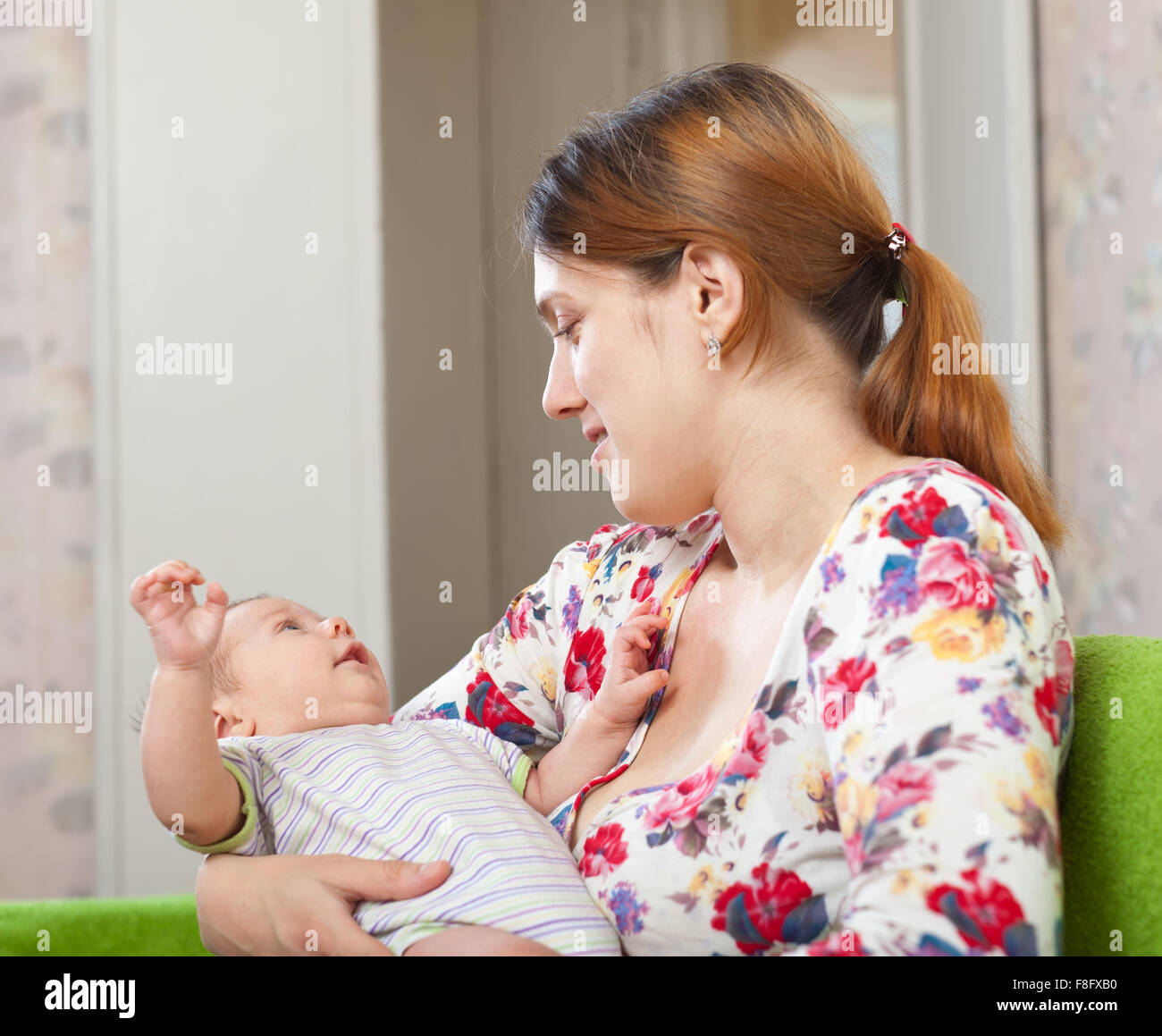 mother with her baby over home interior background Stock Photo - Alamy