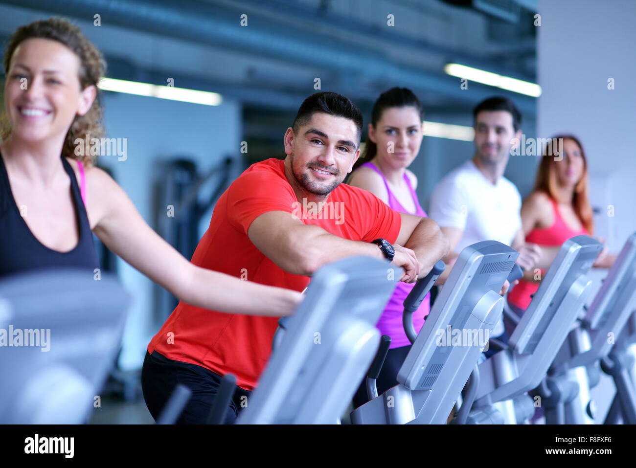 group of young people running on treadmills in modern sport gym Stock ...