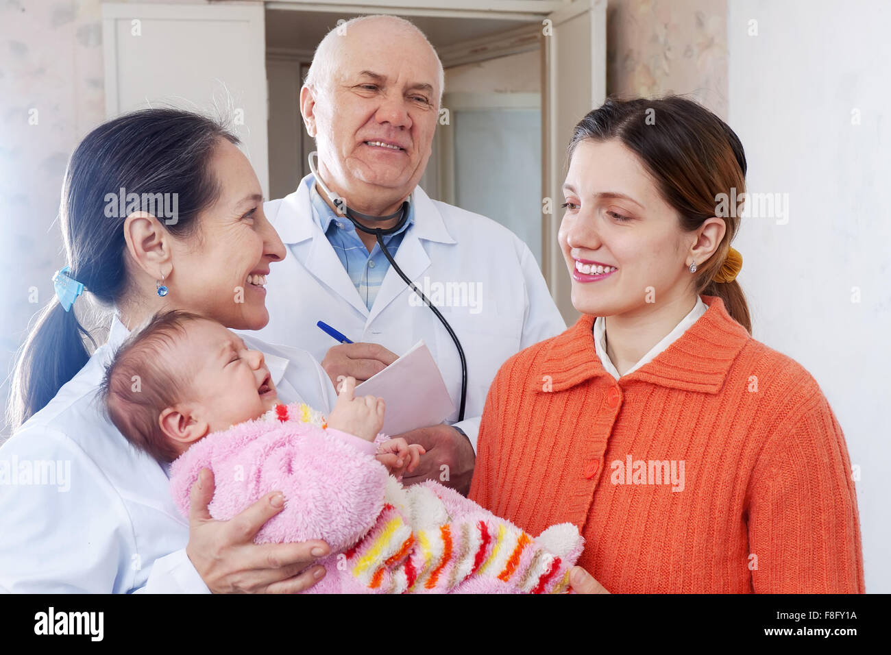 Two pediatrician doctors talks to mother of newborn baby Stock Photo ...