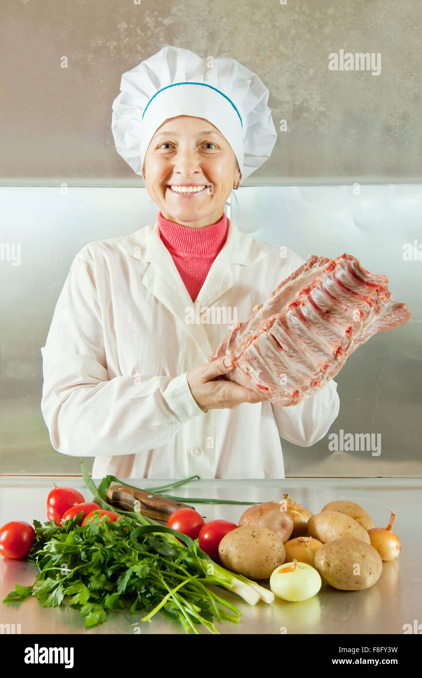 Cook woman with meat and vegetables in kitchen Stock Photo - Alamy