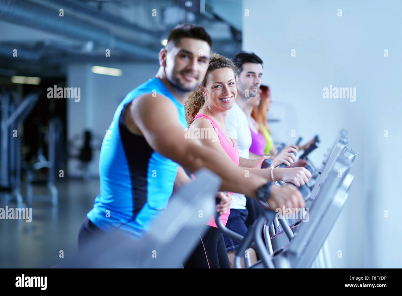 group of young people running on treadmills in modern sport gym Stock ...