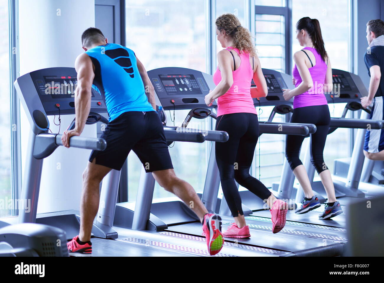 group of young people running on treadmills in modern sport gym Stock ...